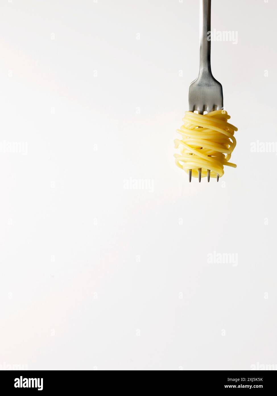 Pasta wrapped around a fork Stock Photo - Alamy