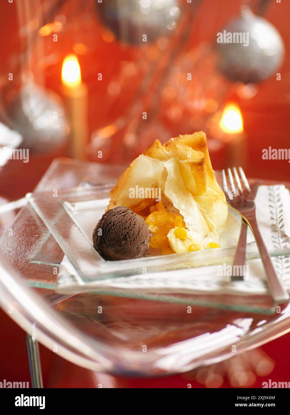 Half apricots in filo pastry and a scoop of chocolate ice cream Stock ...