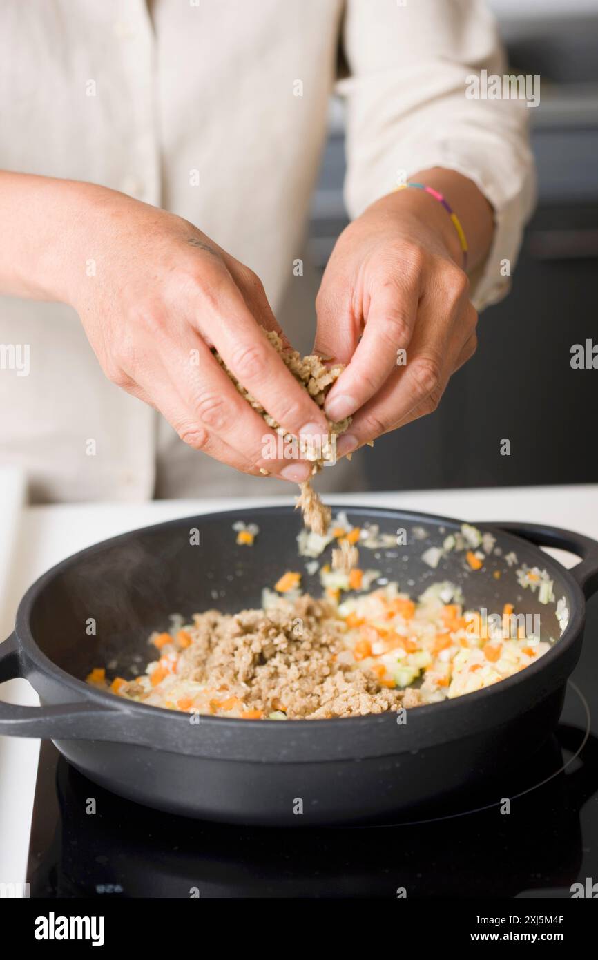 Adding the diced Seitan to the vegetables cooking in the frying pan ...