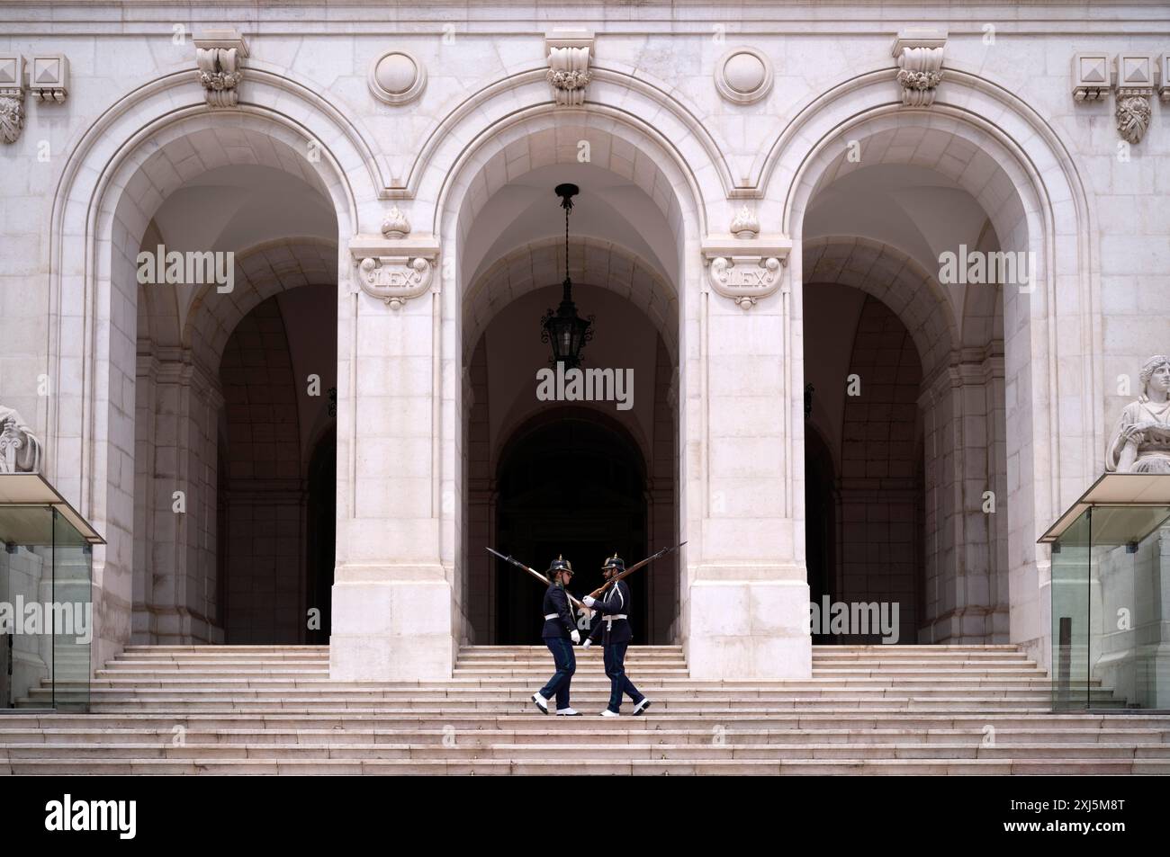 Armed guard on patrol in front of the parliament building Palacio de ...