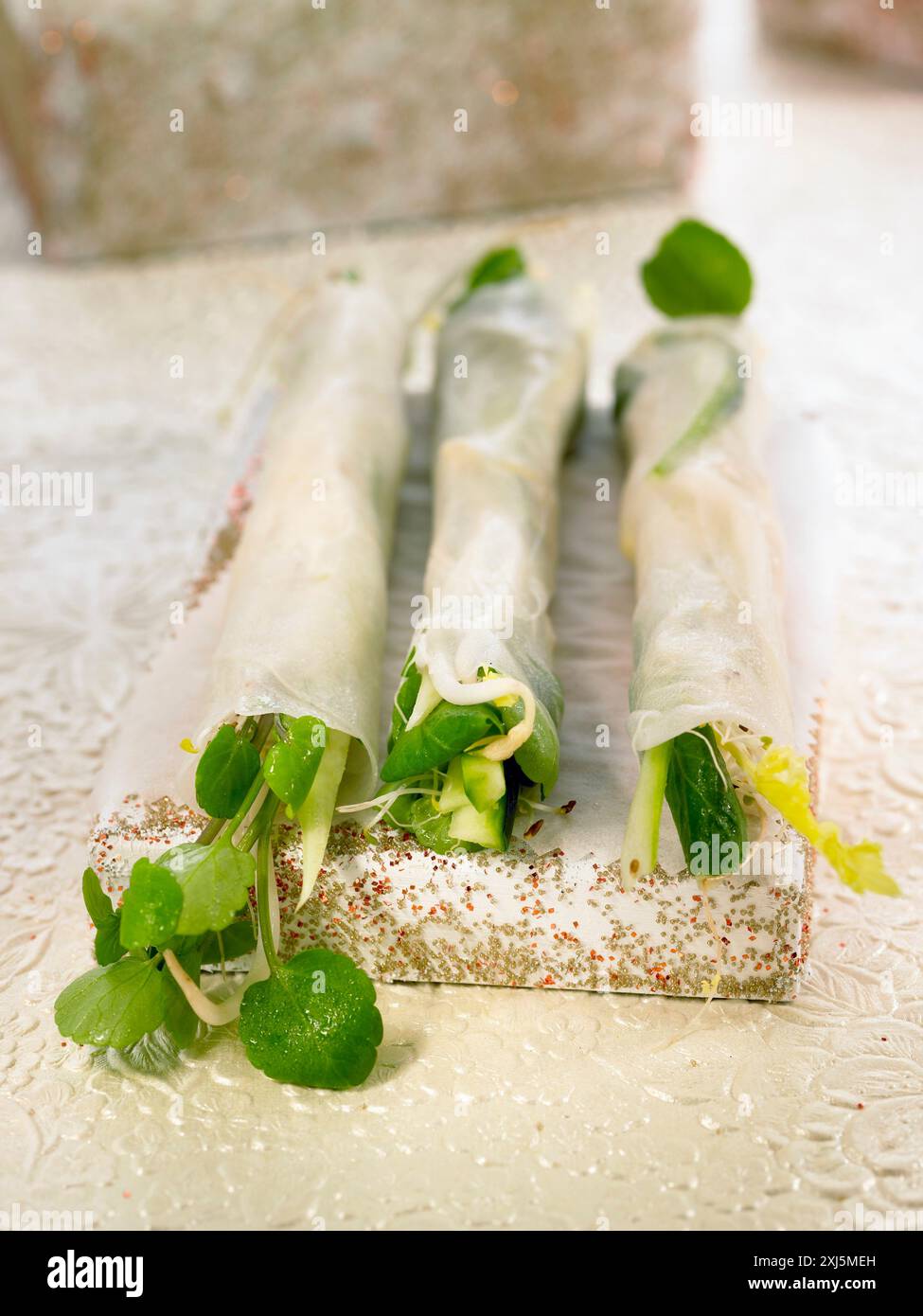Rolled rice sheets with cucumber strips Stock Photo - Alamy