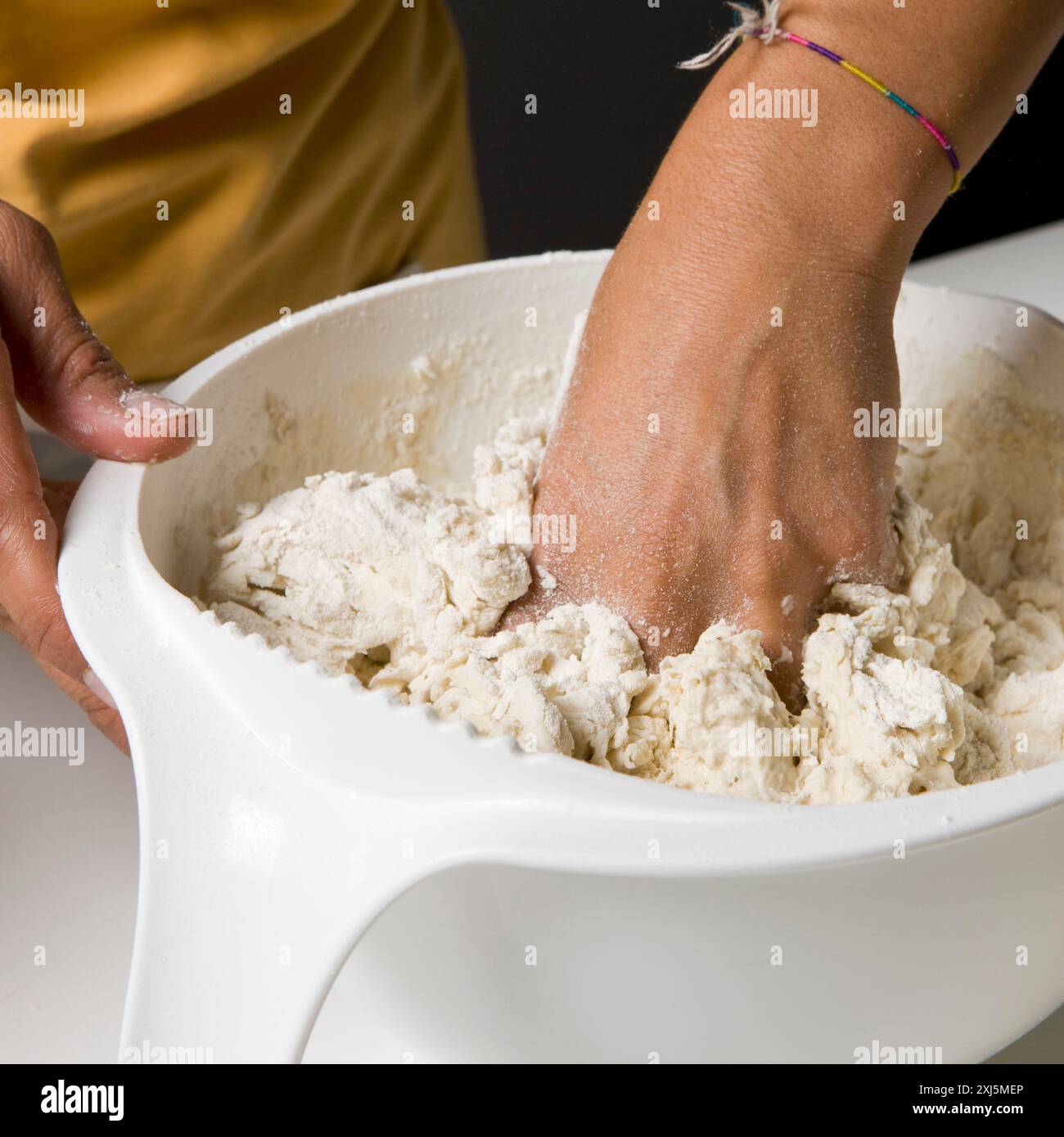 Mixing together the water and flour with your hands Stock Photo - Alamy