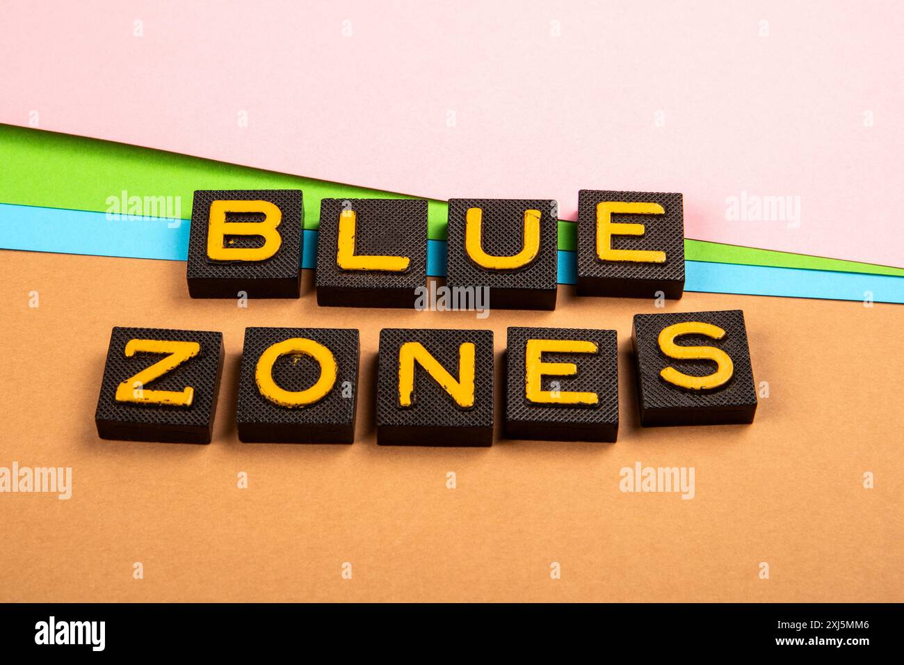 BLUE ZONES. Old letter tiles on a colored paper background Stock Photo ...