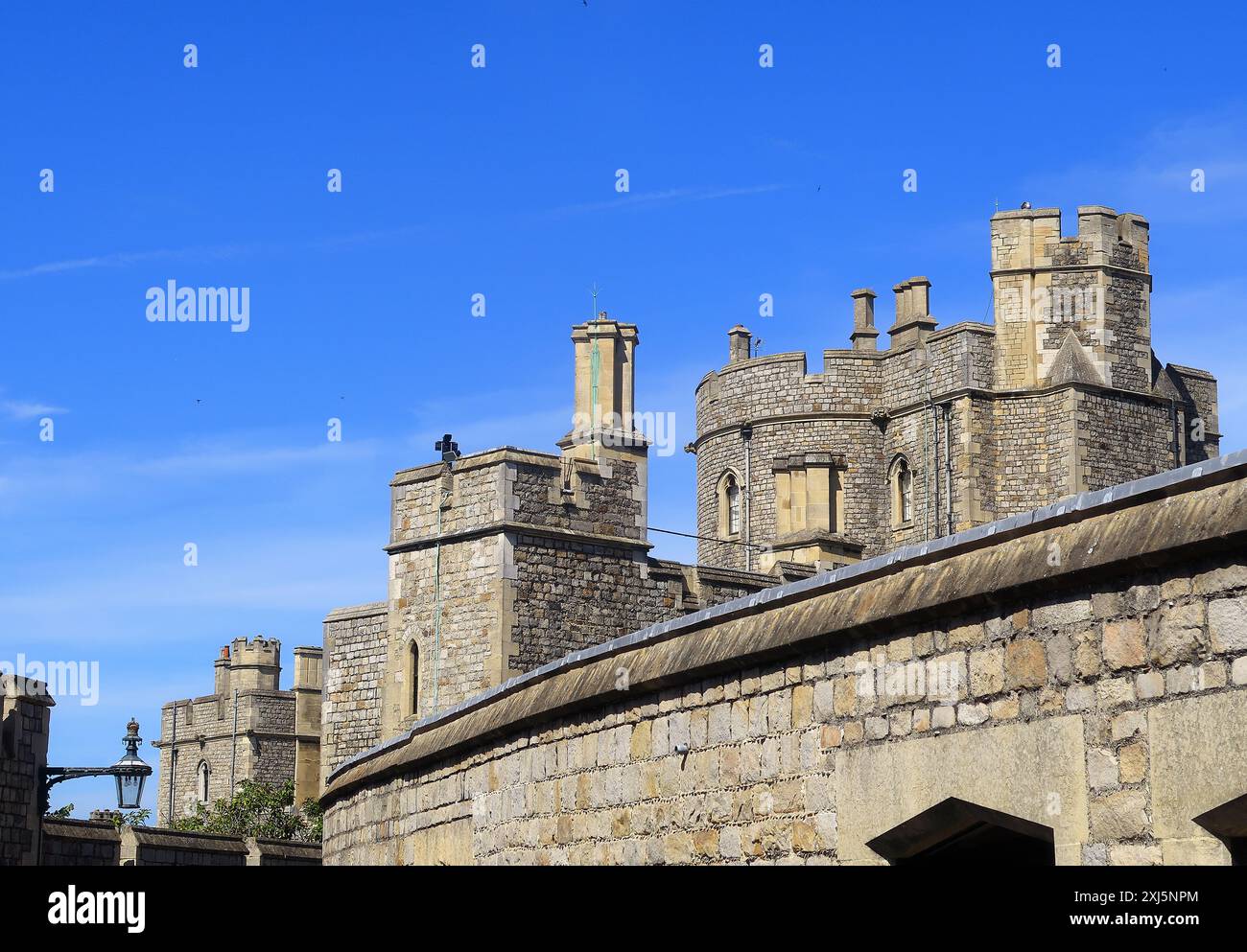 A view looking over a wall at the battlements and towers of Windsor ...