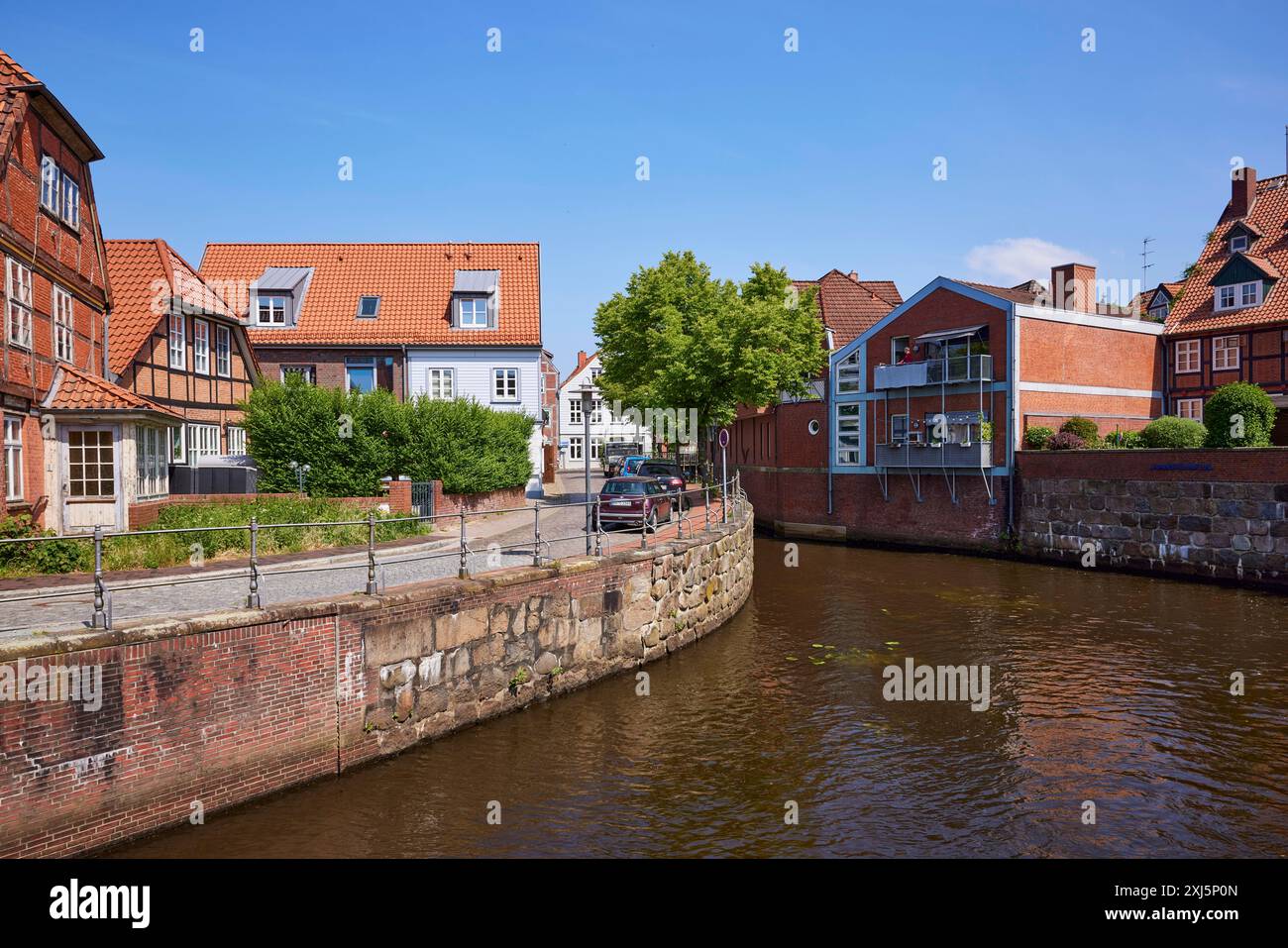 River Schwinge in brick-walled riverbed, street, half-timbered houses ...