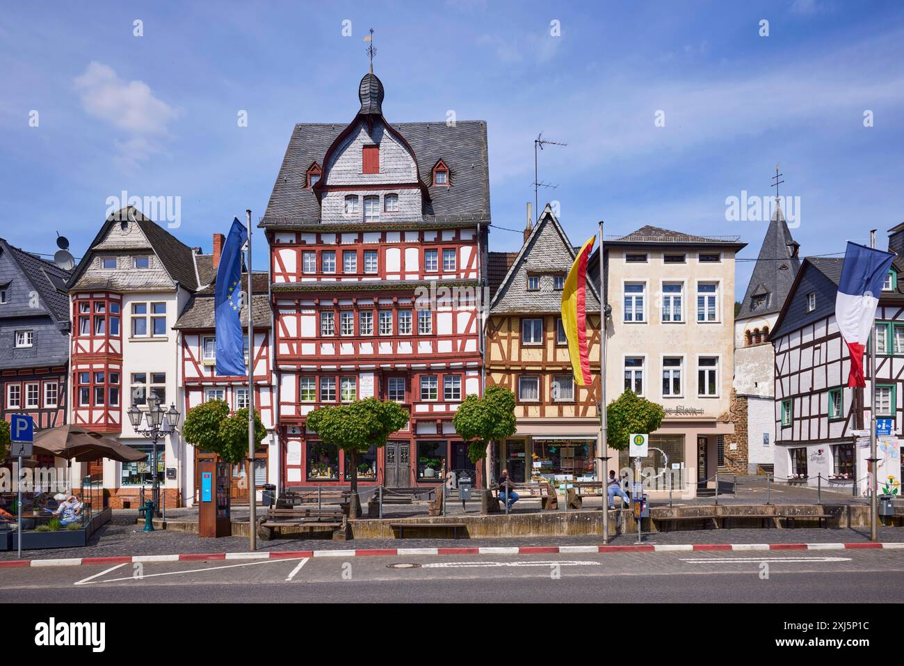 Multi-storey half-timbered houses, Adenau Markt bus stop and flags on ...