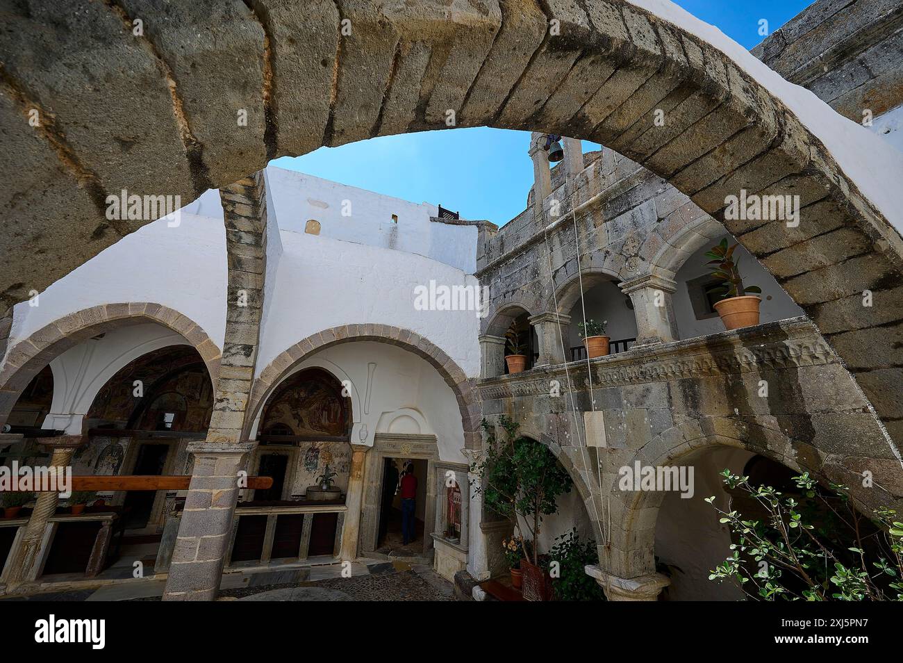 Historic courtyard with stone arches and white walls in a Mediterranean ...