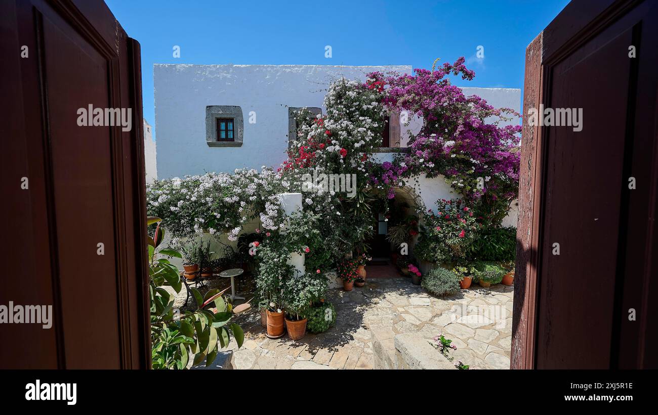 View through Tor tor into a flower-lined courtyard with white walls ...