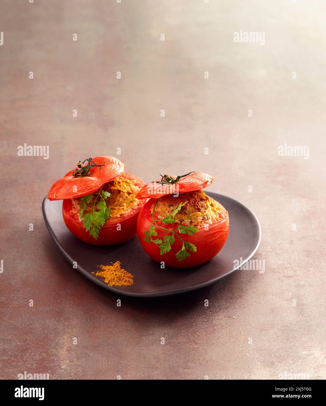 Tomatoes with curry-flavored stuffing Stock Photo - Alamy