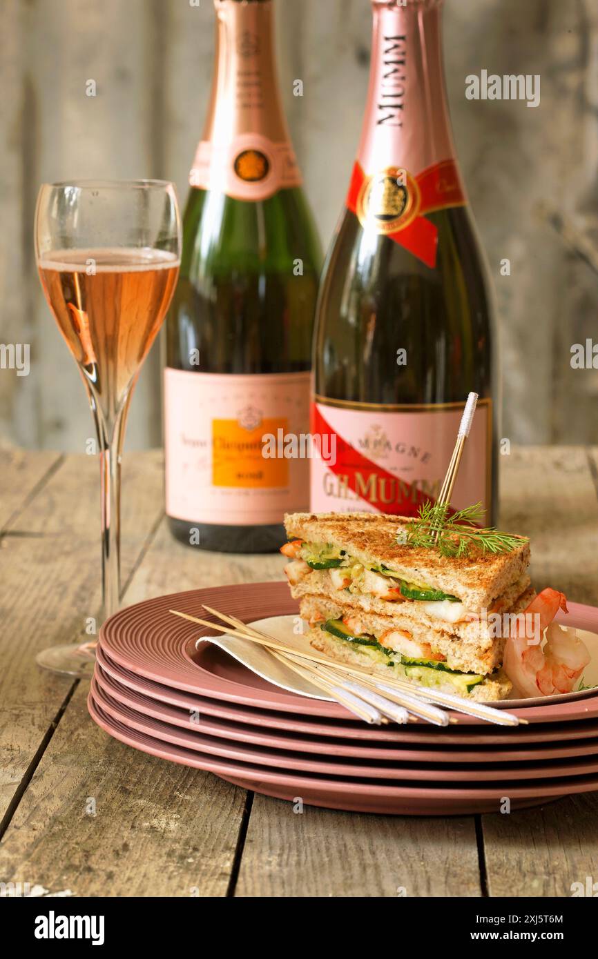 Shrimp club sandwiches and bottles of Rosé Champagne Stock Photo - Alamy