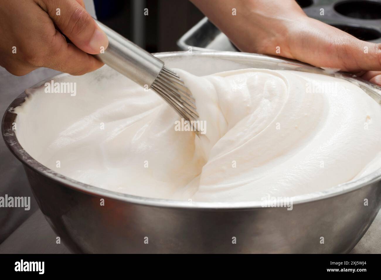Mixing the prepartion with a whisk Stock Photo - Alamy