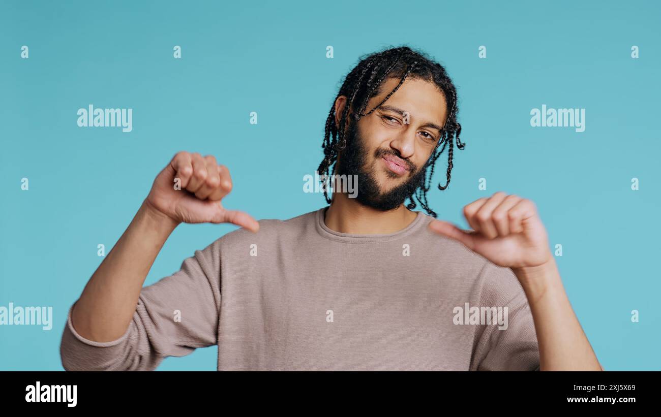 Upset Middle Eastern man showing thumbs down sign gesturing ...
