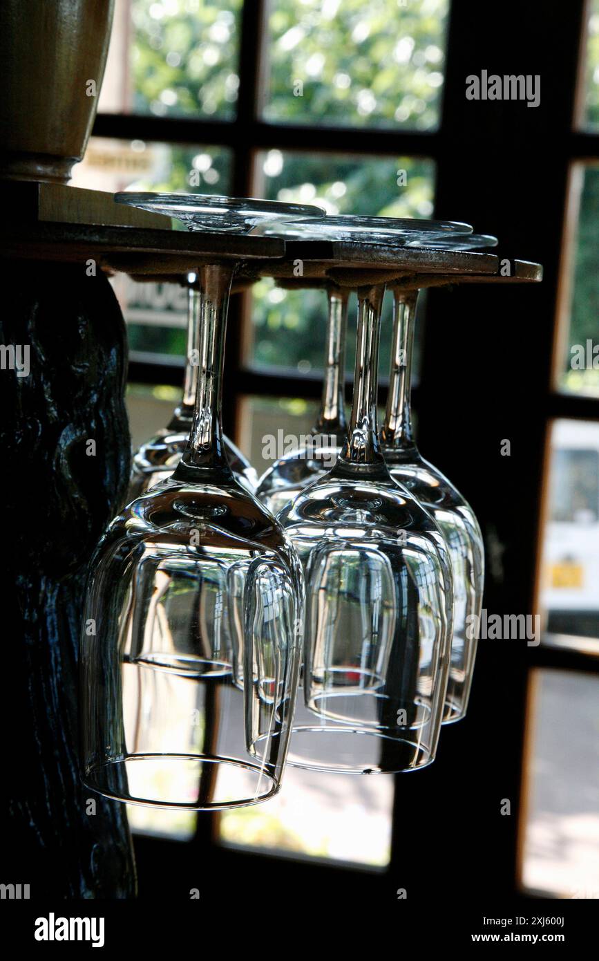Empty glasses hanging Stock Photo - Alamy