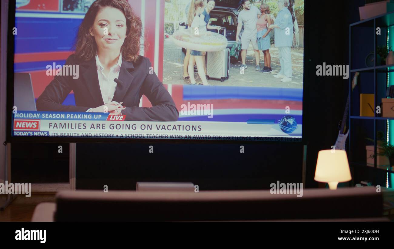 Large TV screen showing news broadcast reportages on summer vacations ...