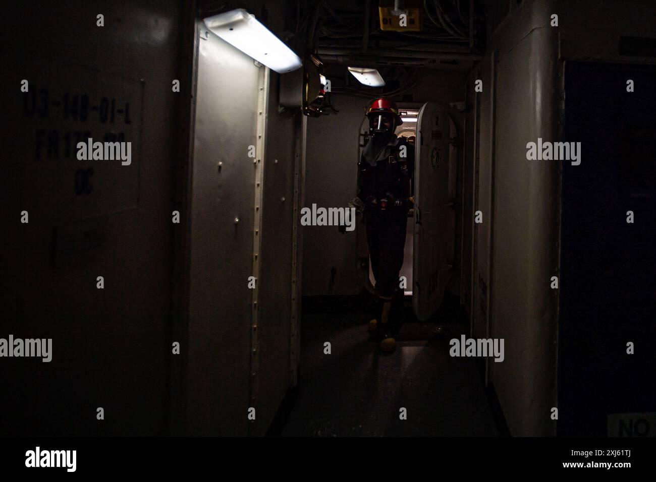 A Sailor opens a hatch during a general quarters drill aboard the ...