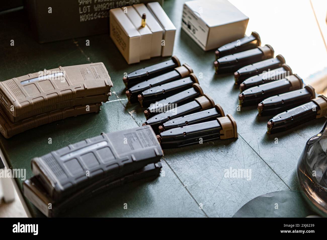 U.S. Air Force M4 carbine and M18 pistol magazines rest on a table at ...