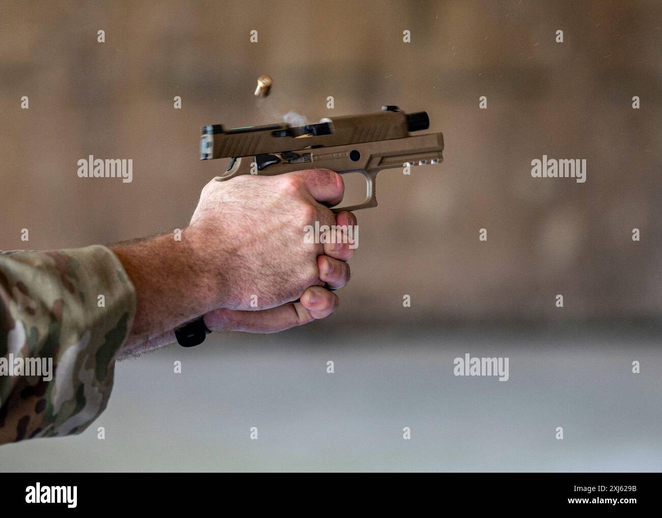 U.S. Air Force Col. Paul Sheets, 23rd Wing commander, fires an M18 ...