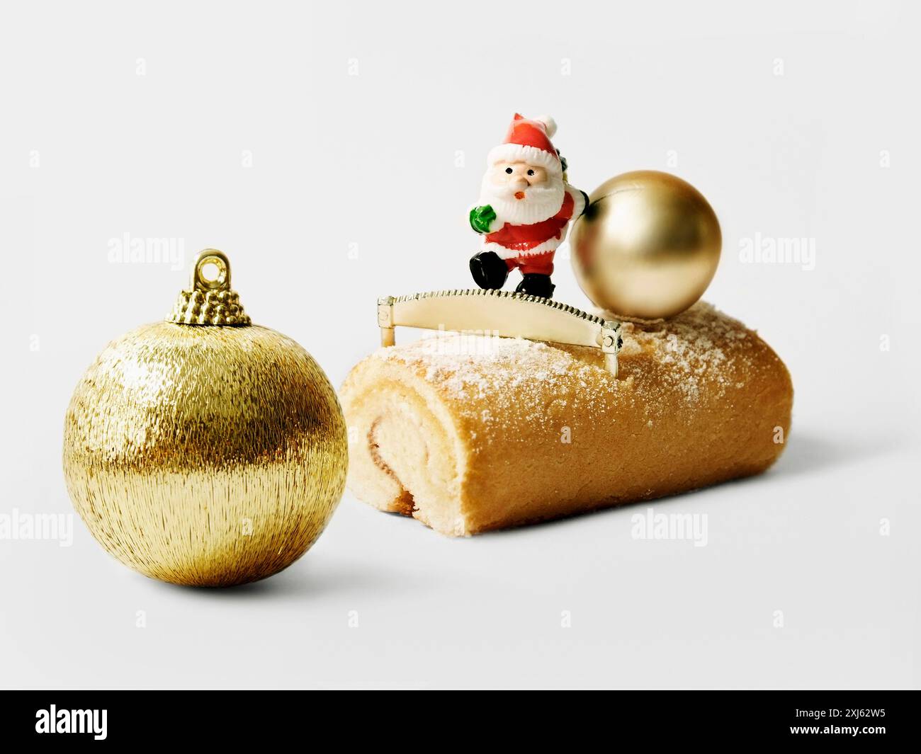 Christmas individual log cake with golden Christmas tree ball Stock ...
