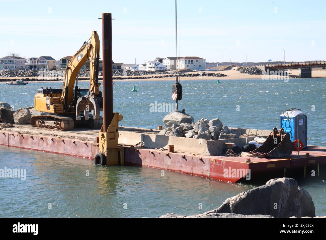 Contractor Lucianos Excavation moving armor stone for placement on the ...