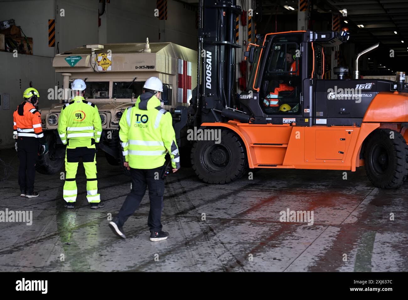 Contractors supporting the 838th Transportation Battalion use a ...