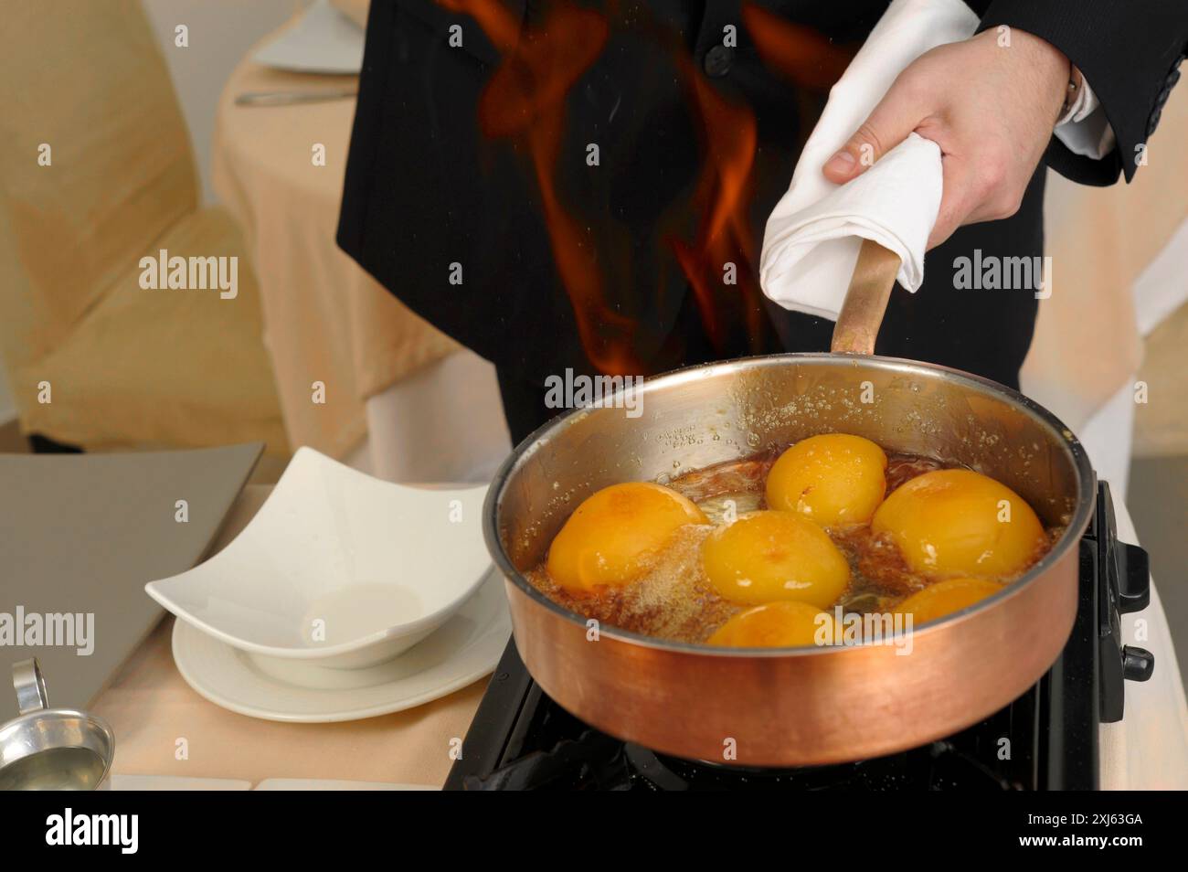 Preparing peaches flambé Stock Photo - Alamy