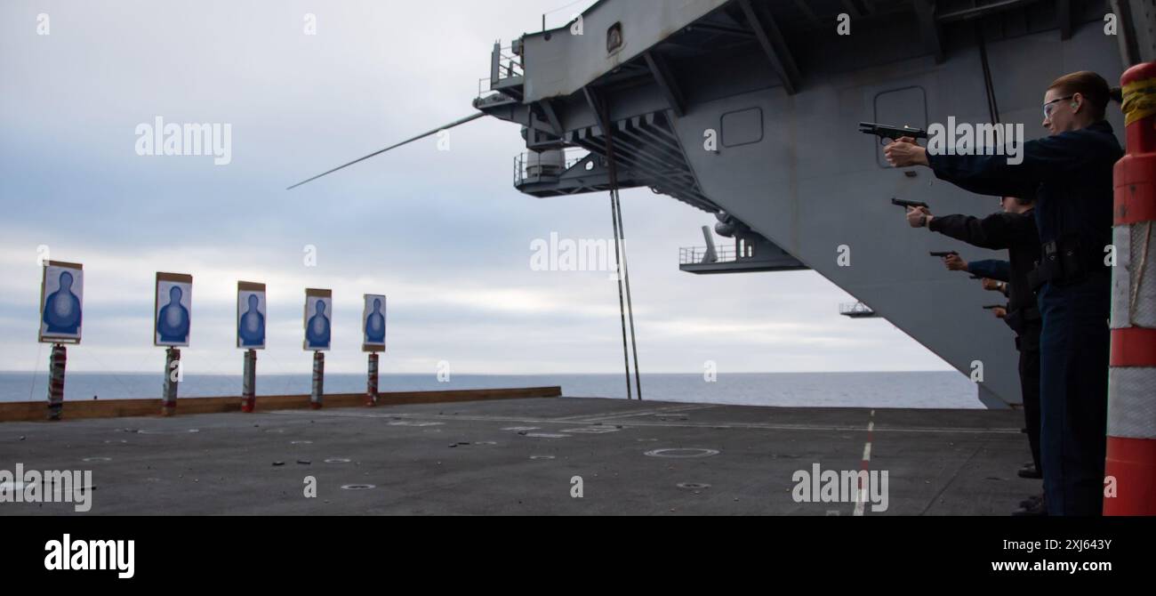 Sailors fire M9 service pistols during a small arms live-fire exercise ...
