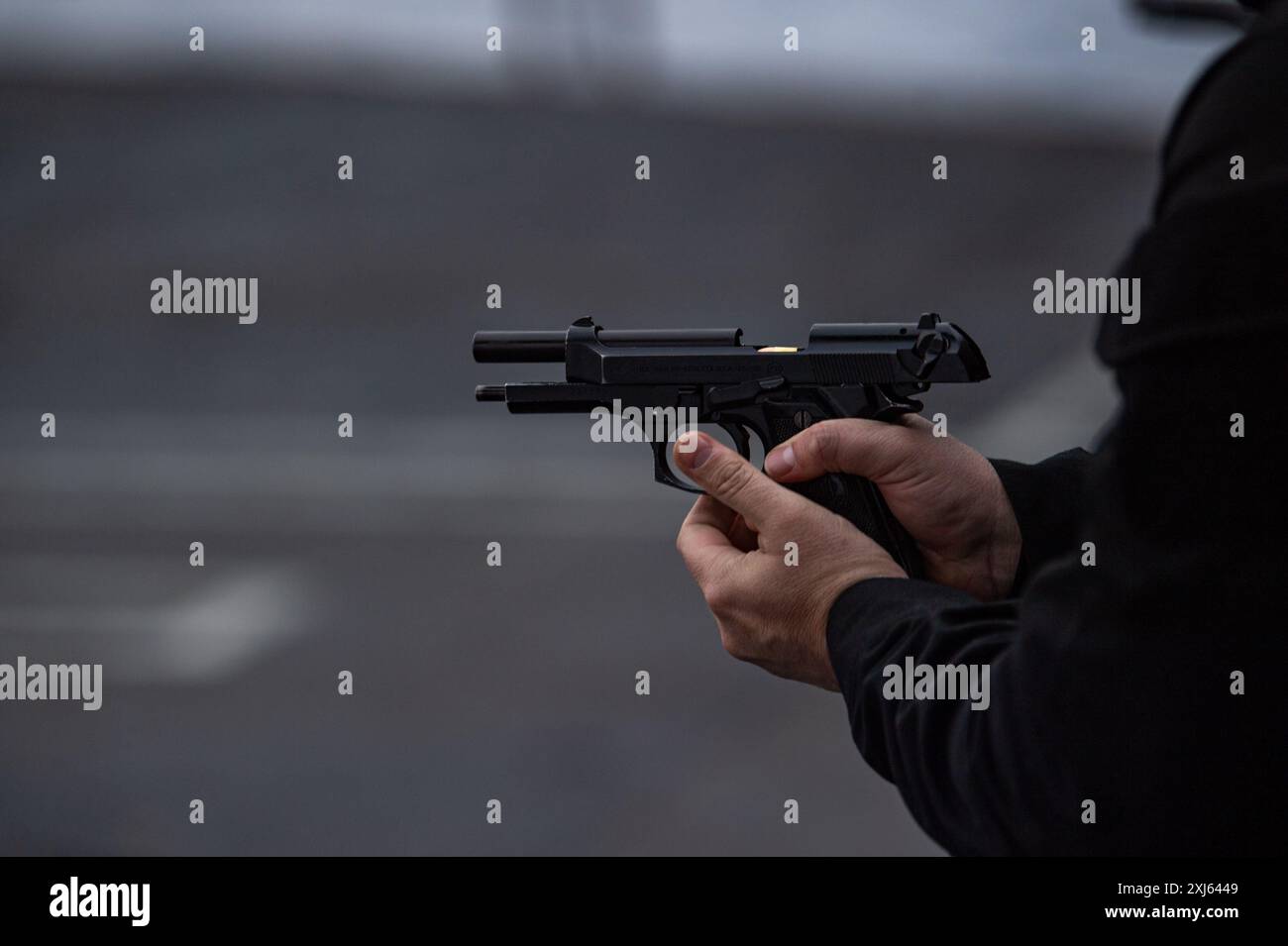 A Sailor loads an M9 service pistol during a small arms live-fire ...