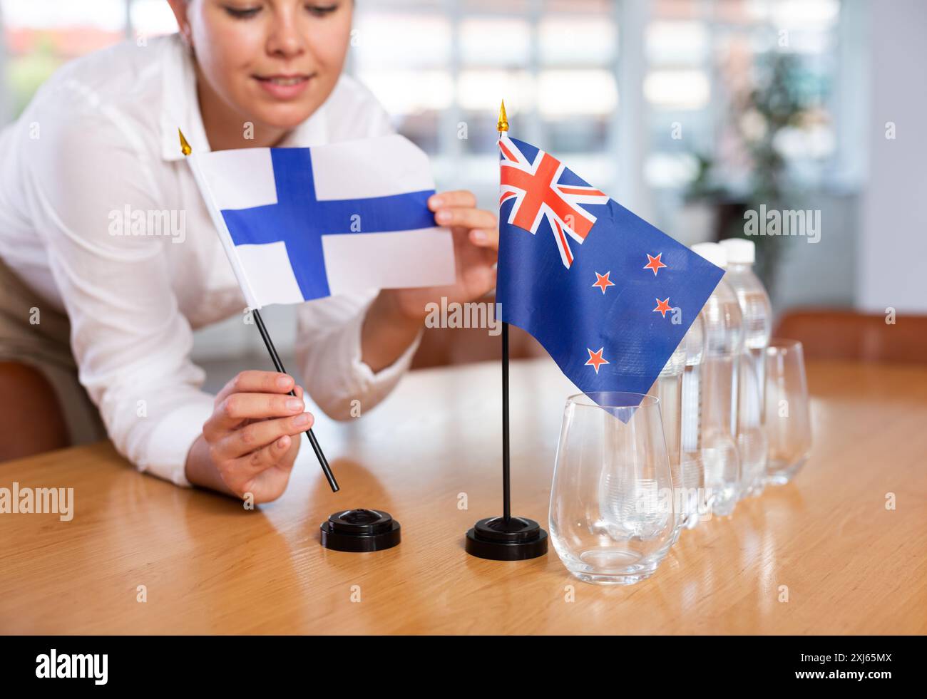 Female secretary places flags of the Australia and Finland flag on the ...