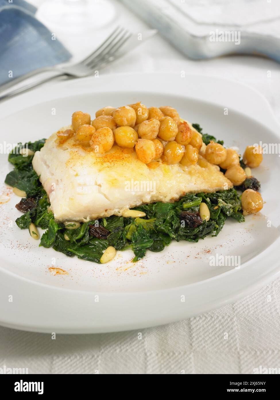 Salt-cod with chickpeas,spinach and pine nuts Stock Photo - Alamy