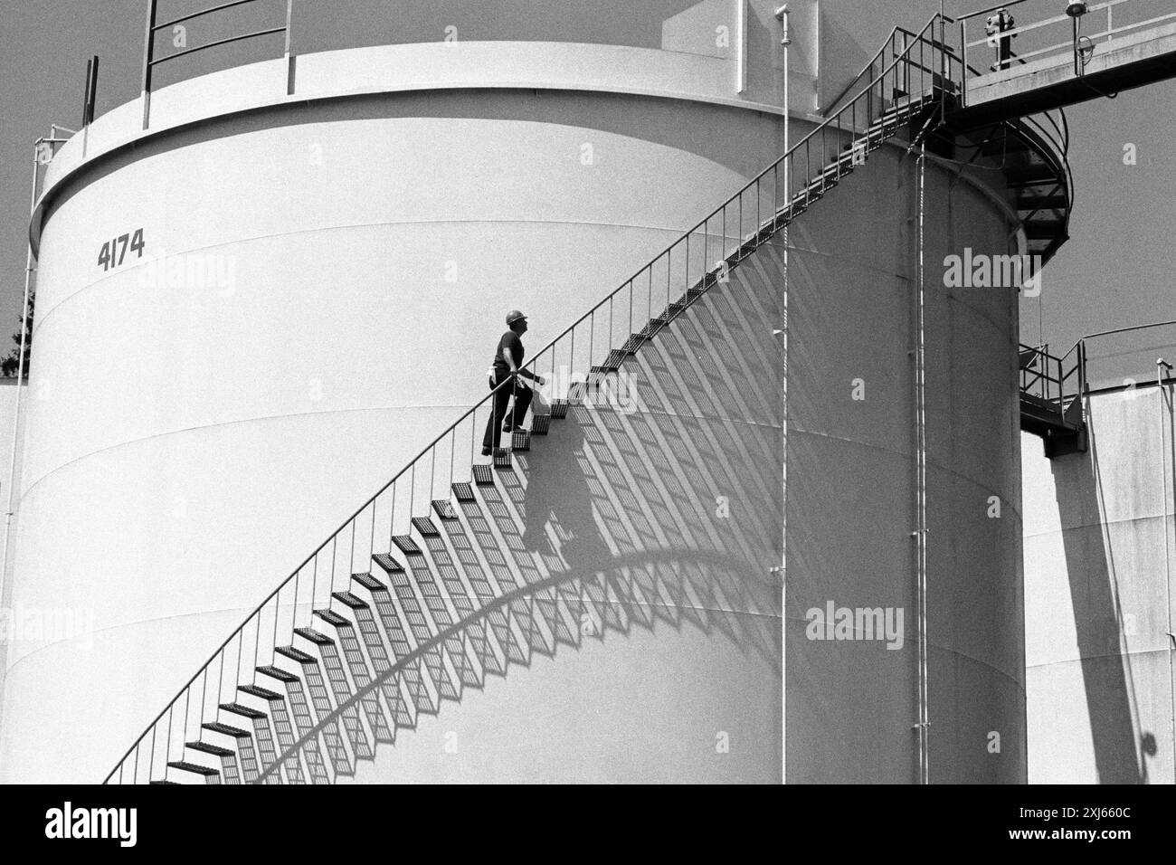 1984 Inspector Climbing Stairs of Oil Storage Tank Stock Photo - Alamy