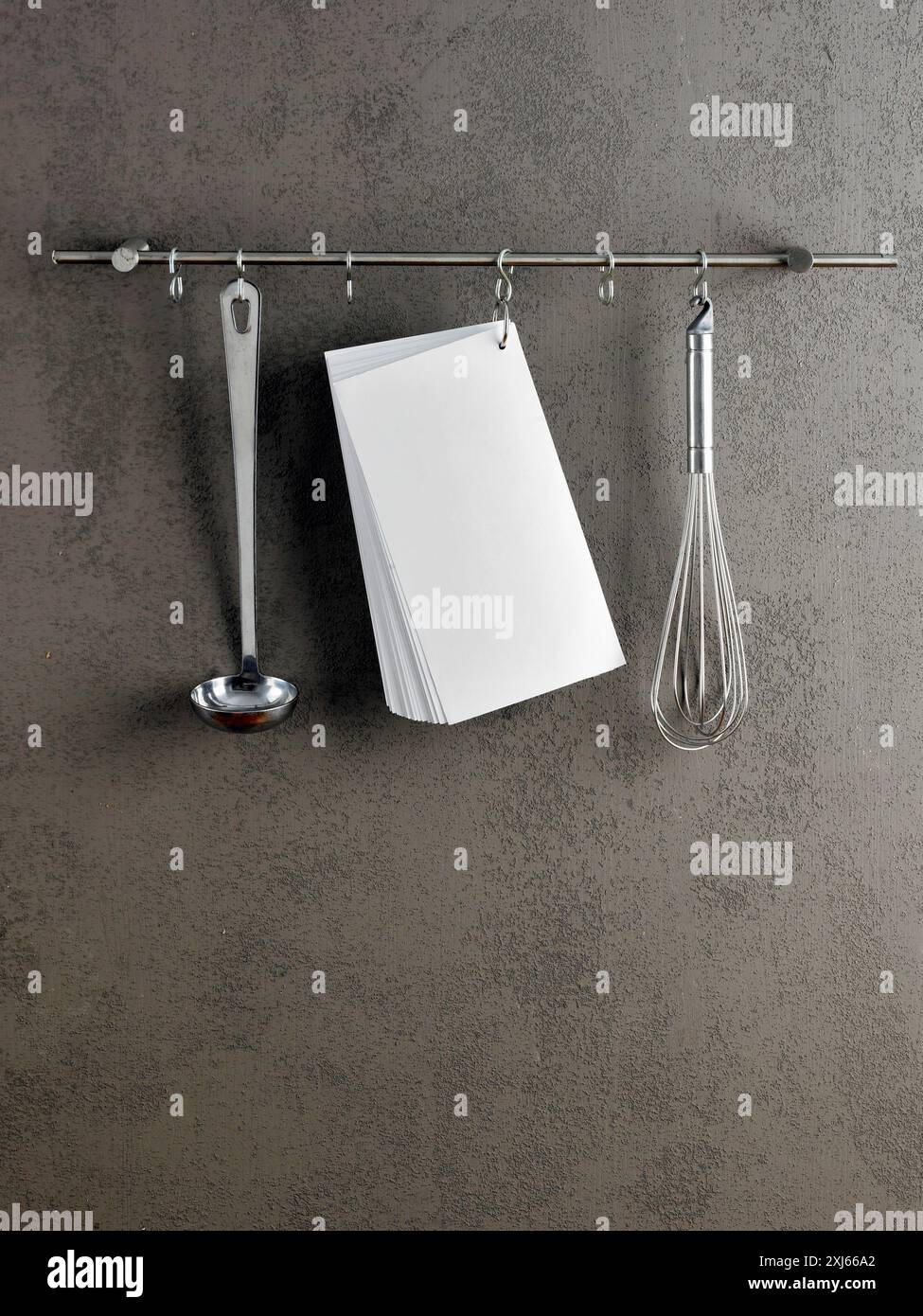 Cooking implements hanging on a wall Stock Photo - Alamy