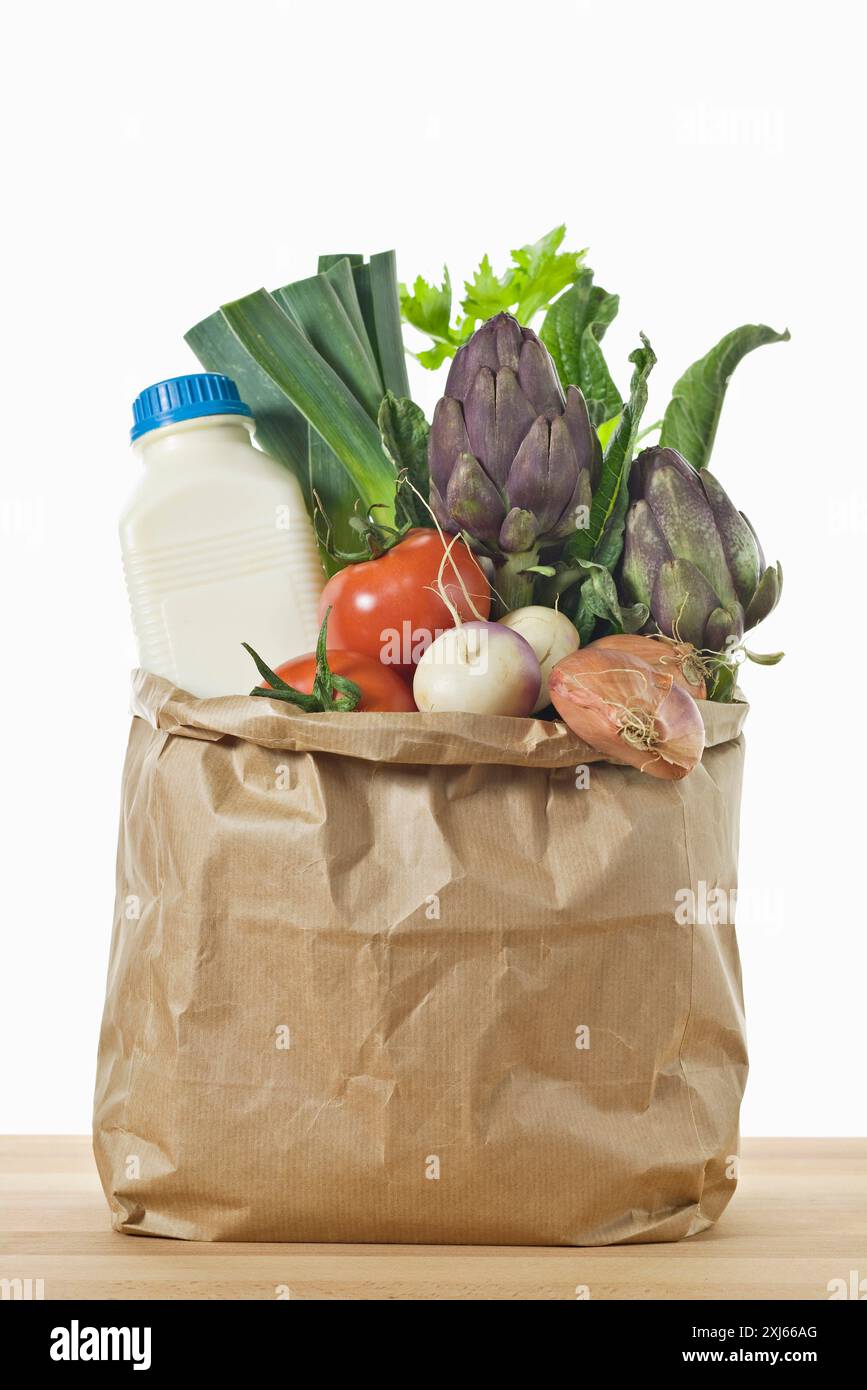 Vegetables and a bottle of milk in a brown paper bag Stock Photo - Alamy