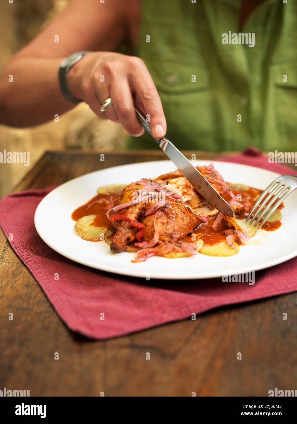 Chicken marinated in onions and Roucou Stock Photo - Alamy