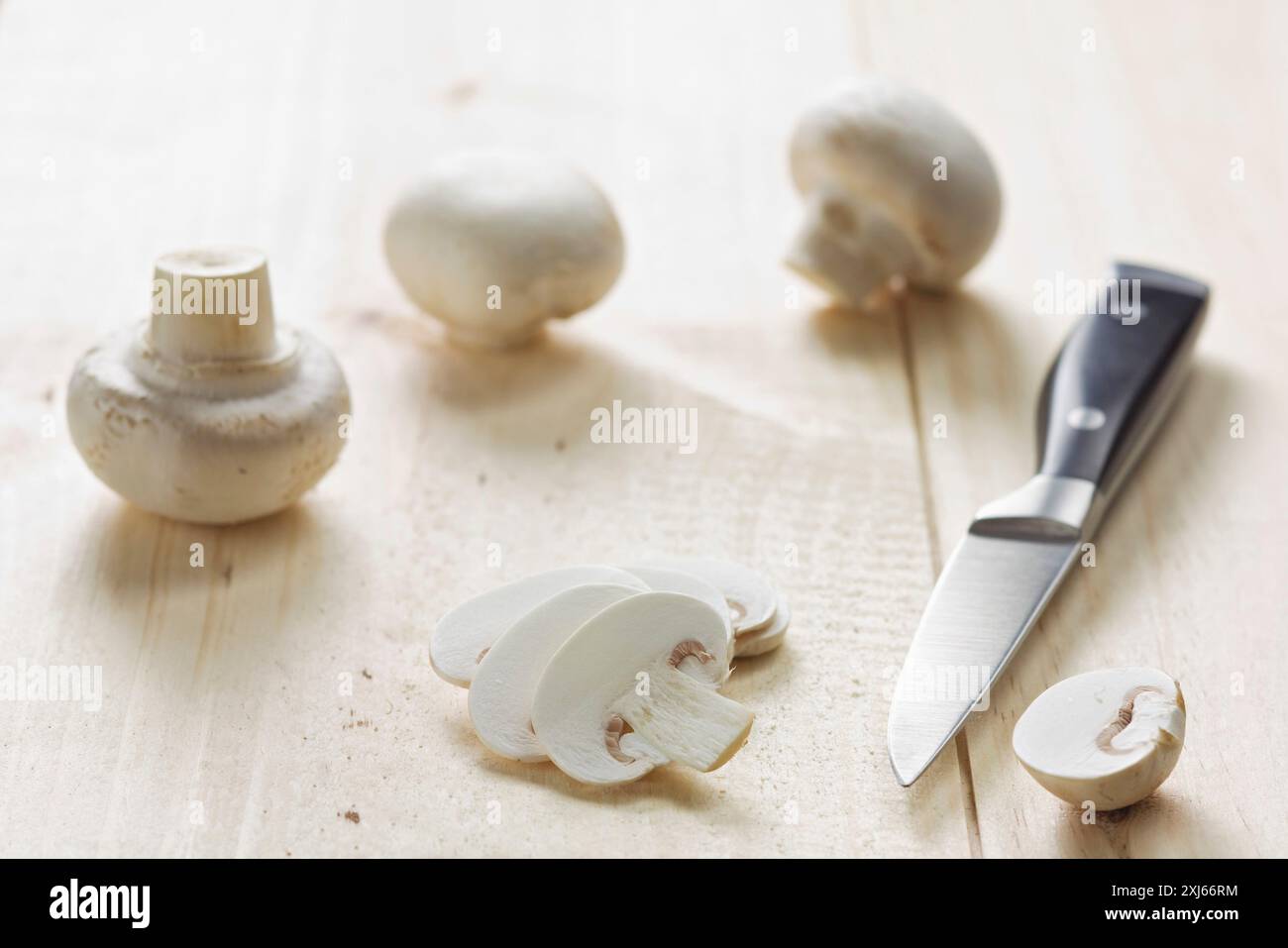 Thinly slicing the button mushrooms Stock Photo - Alamy