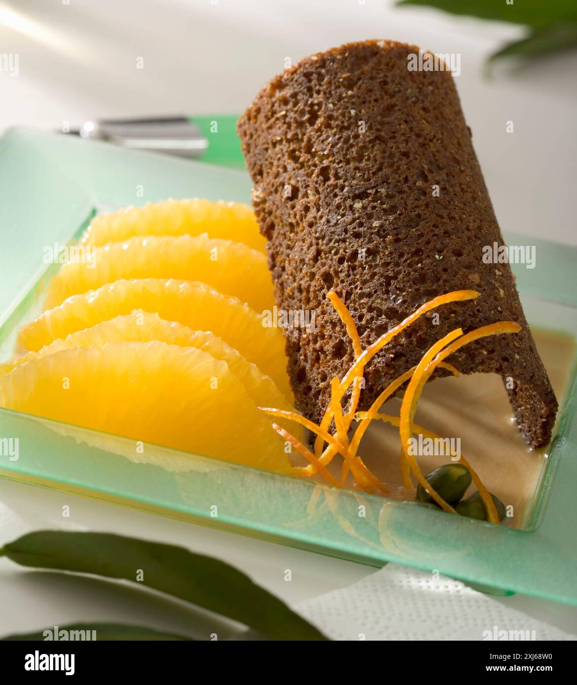 Orange fruit salad with gingerbread and milk jam sauce Stock Photo - Alamy