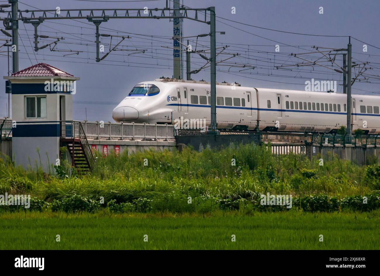 A Chinese CRH2A bullet train based on the Japanese E2 shinkansen approaches Jiaxing South ...