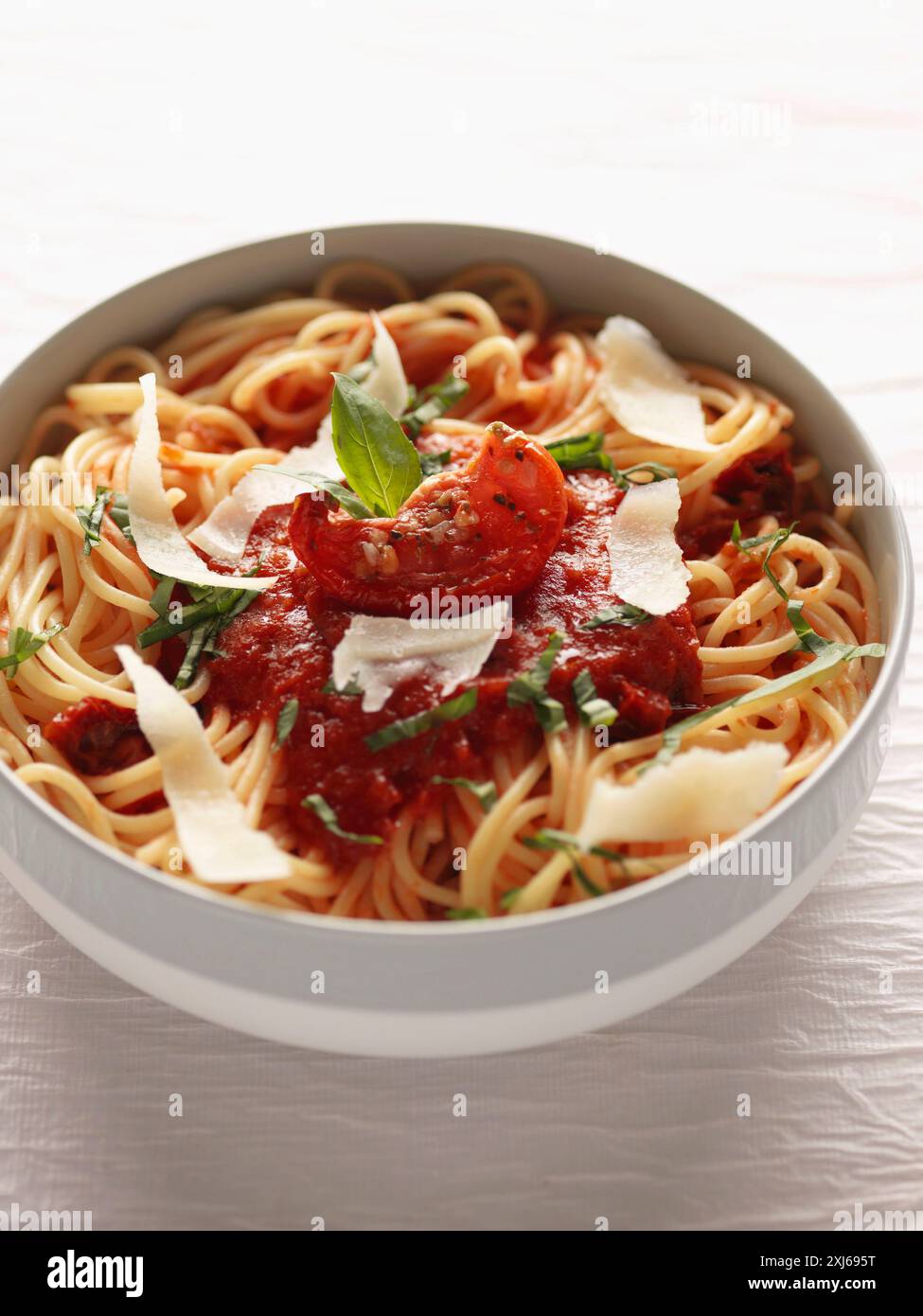 Spaghettis with sun-dried tomato puree,basil and parmesan Stock Photo ...