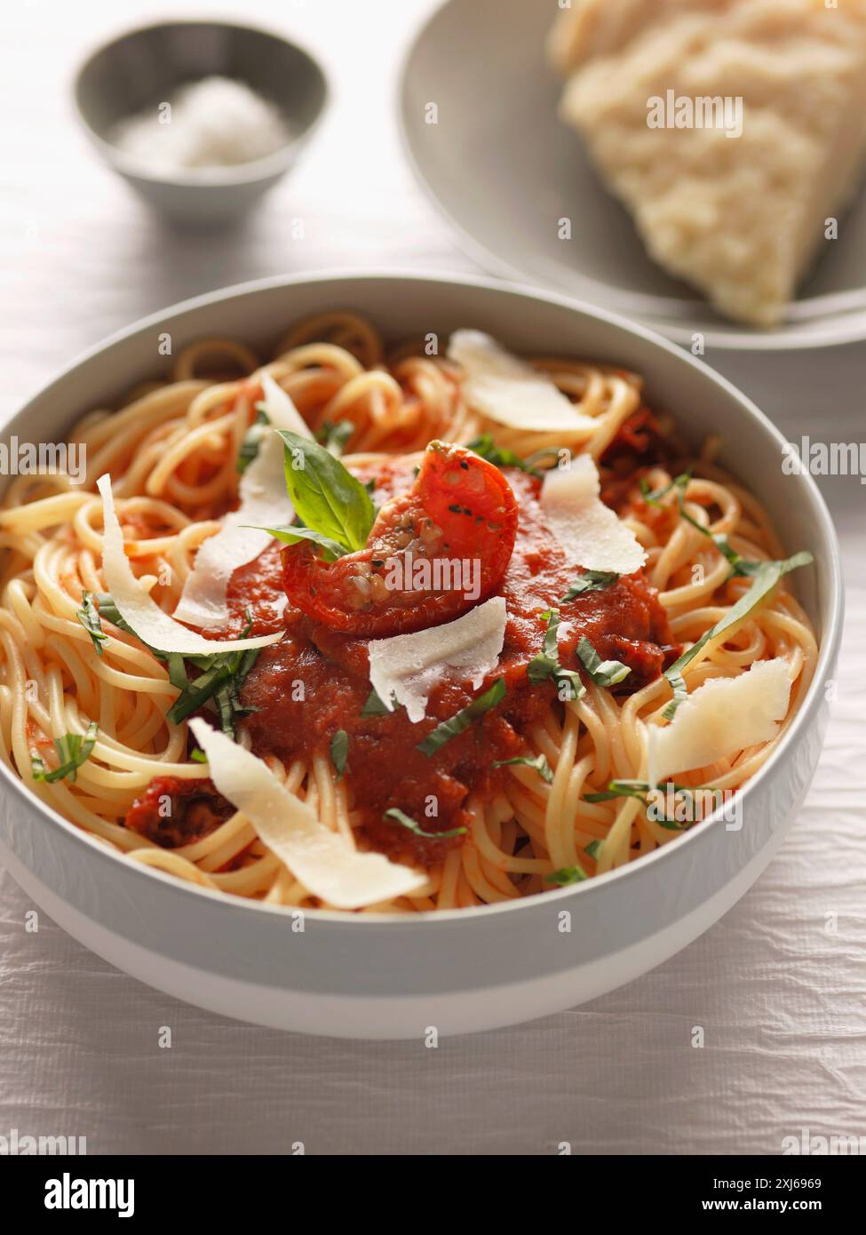 Spaghettis with sun-dried tomato puree,basil and parmesan Stock Photo ...