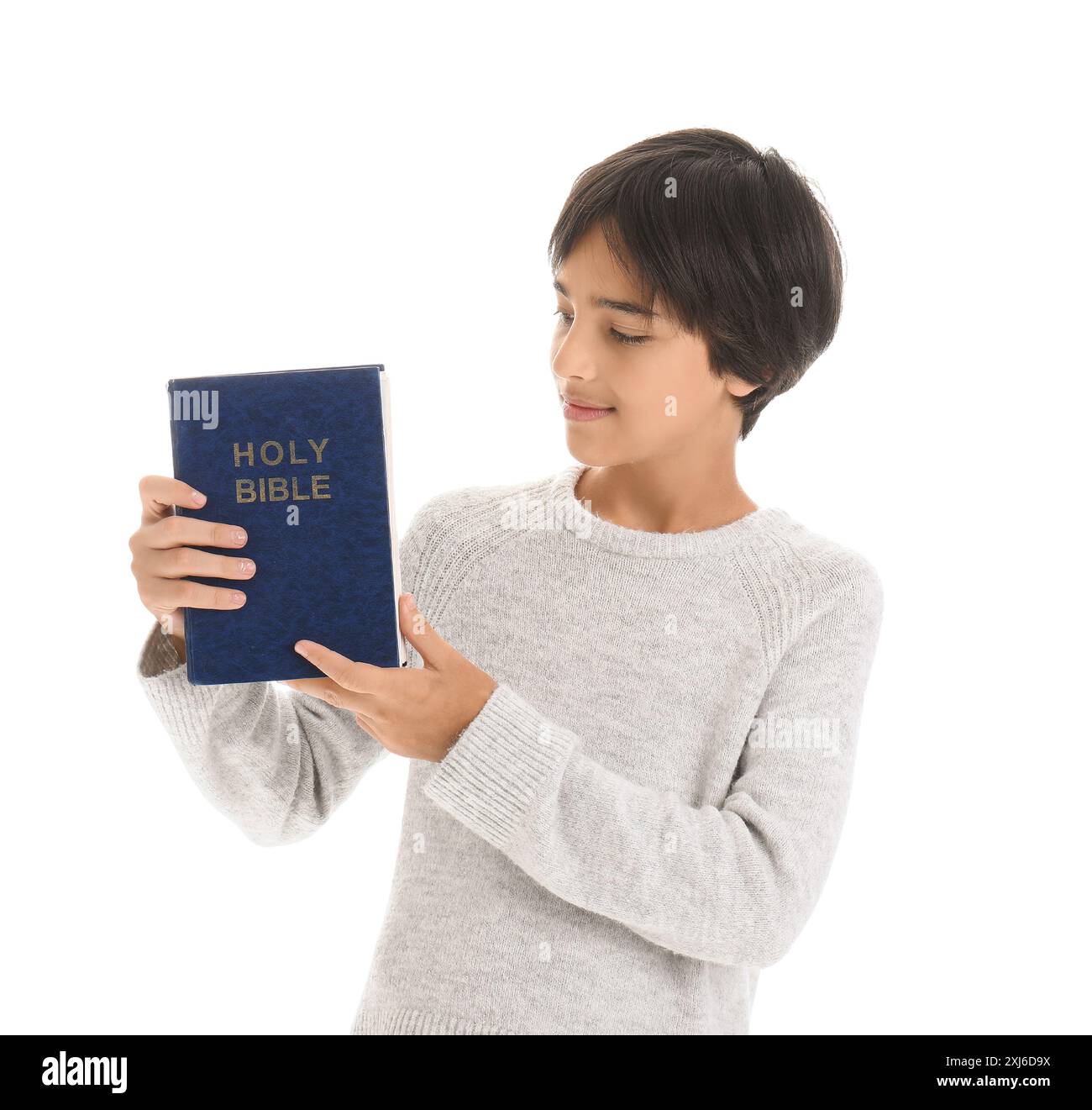 Little boy with Bible isolated on white background Stock Photo - Alamy