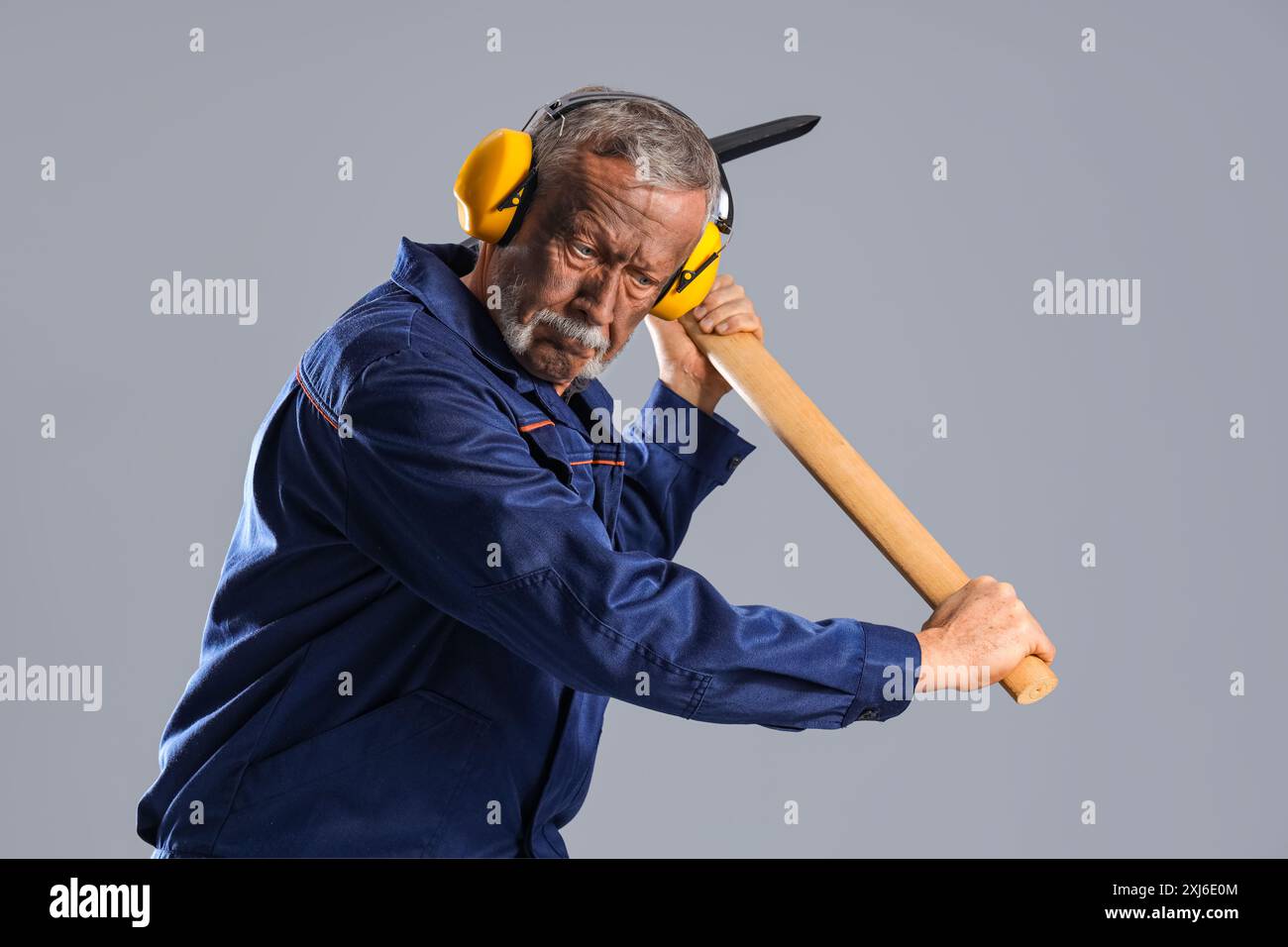 Mature miner man with pick axe on grey background Stock Photo - Alamy