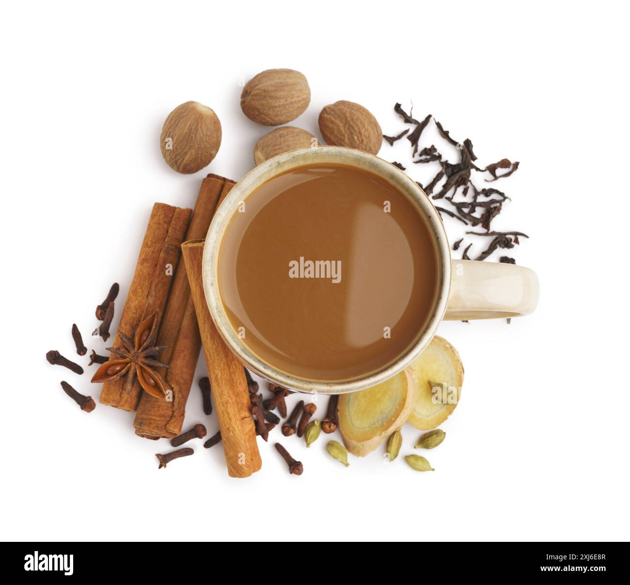 Cup of delicious masala tea with different spices and walnuts on white ...