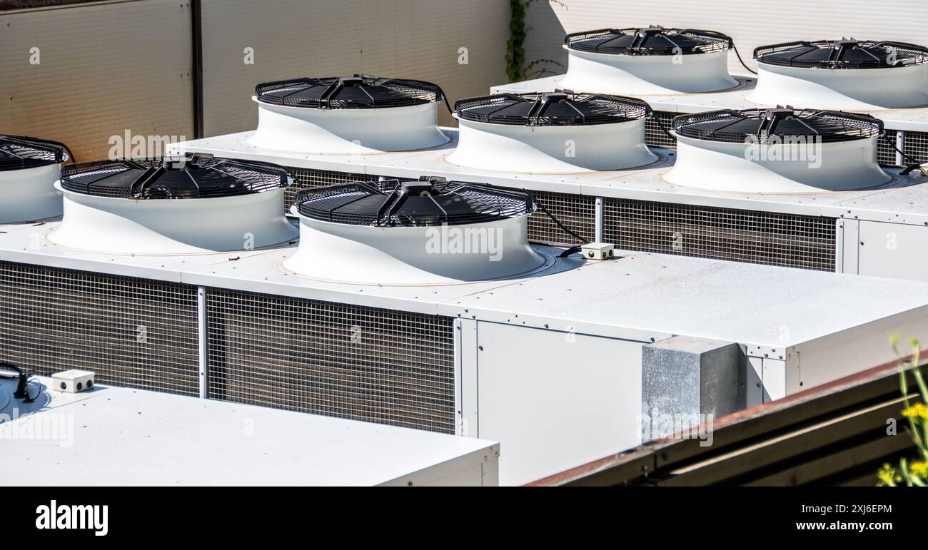 Multiple industrial air conditioning units installed on a commercial building's roof, showcasing ...