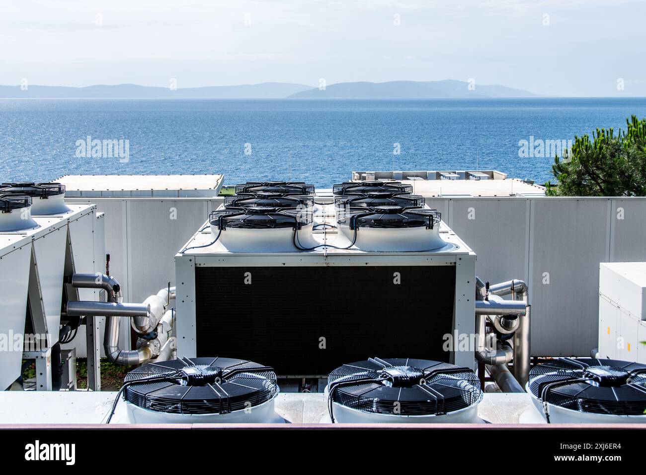 Multiple industrial air conditioning units on a building rooftop ...