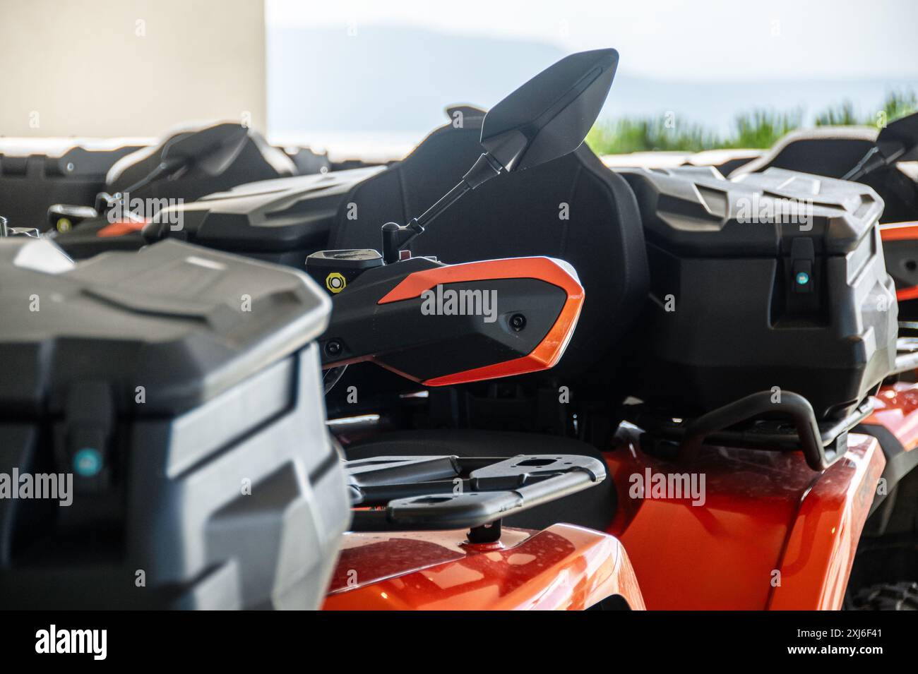 Lined up outdoors, these modern red and black all-terrain vehicles ...