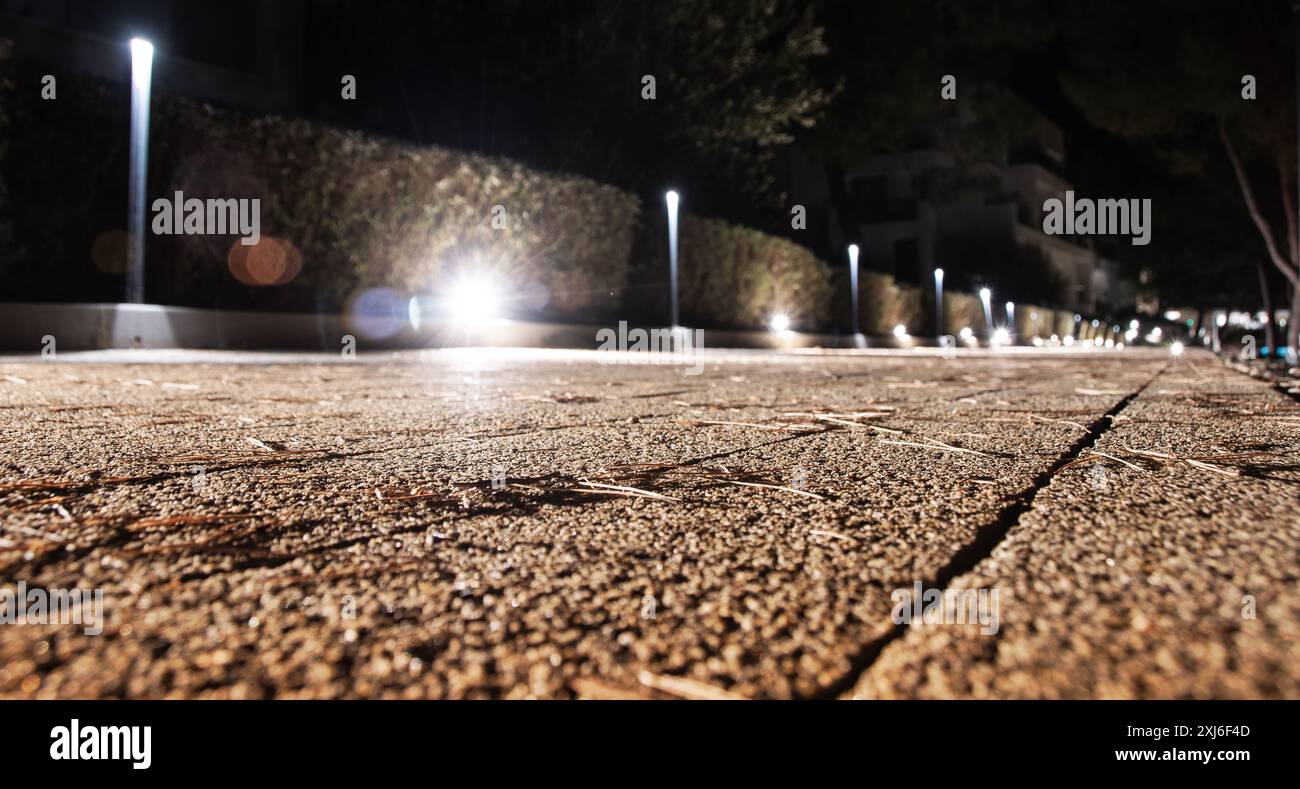 Captivating nighttime urban scene with LED lights lining a pathway. The ...