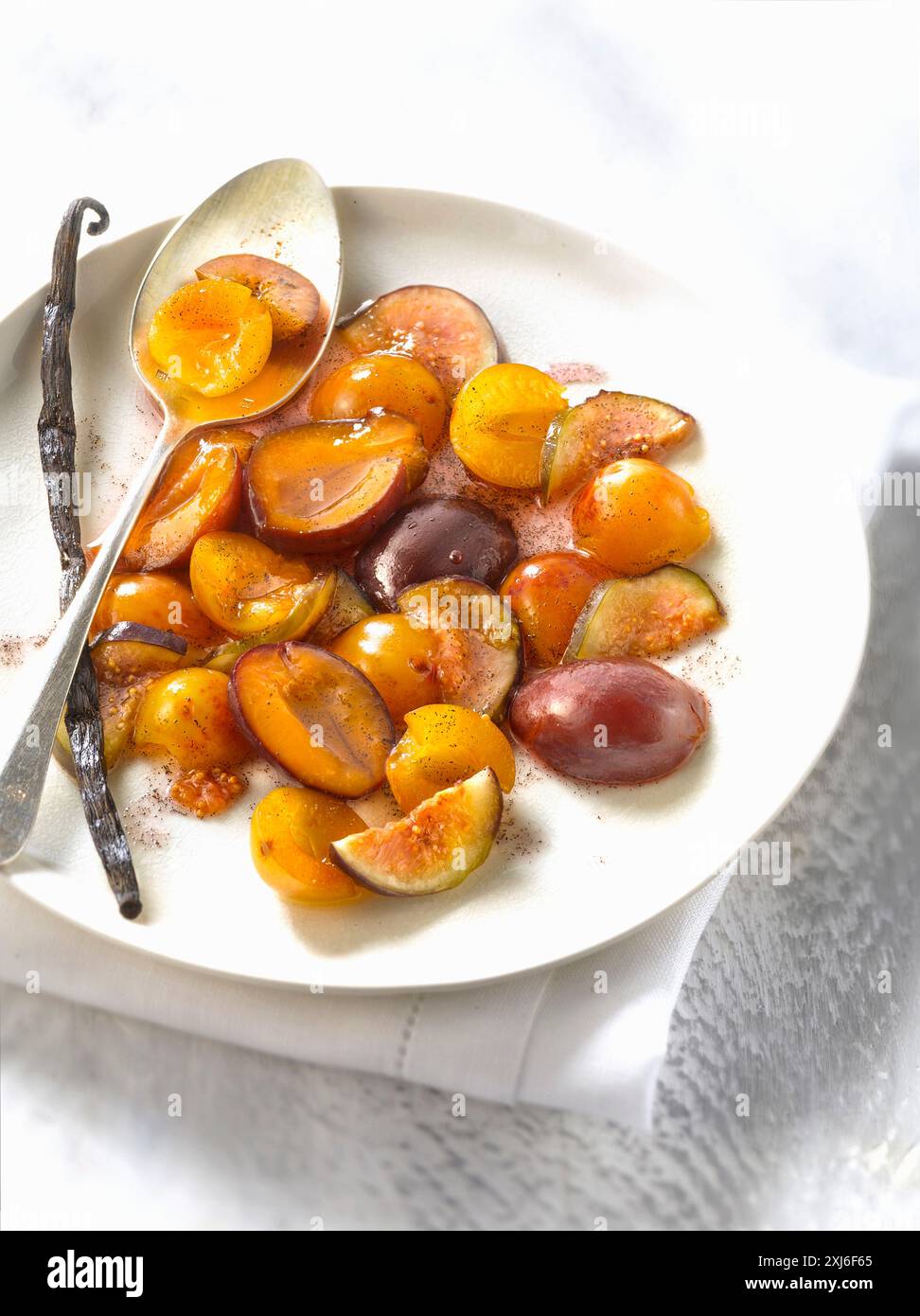Warm fig and plum vanilla-flavored fruit salad Stock Photo - Alamy