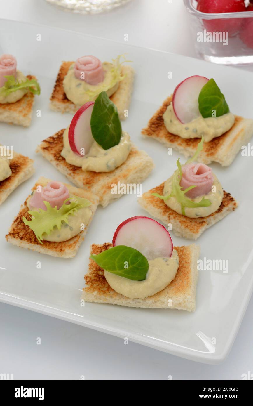 Hummus,radish and ham canapés Stock Photo - Alamy
