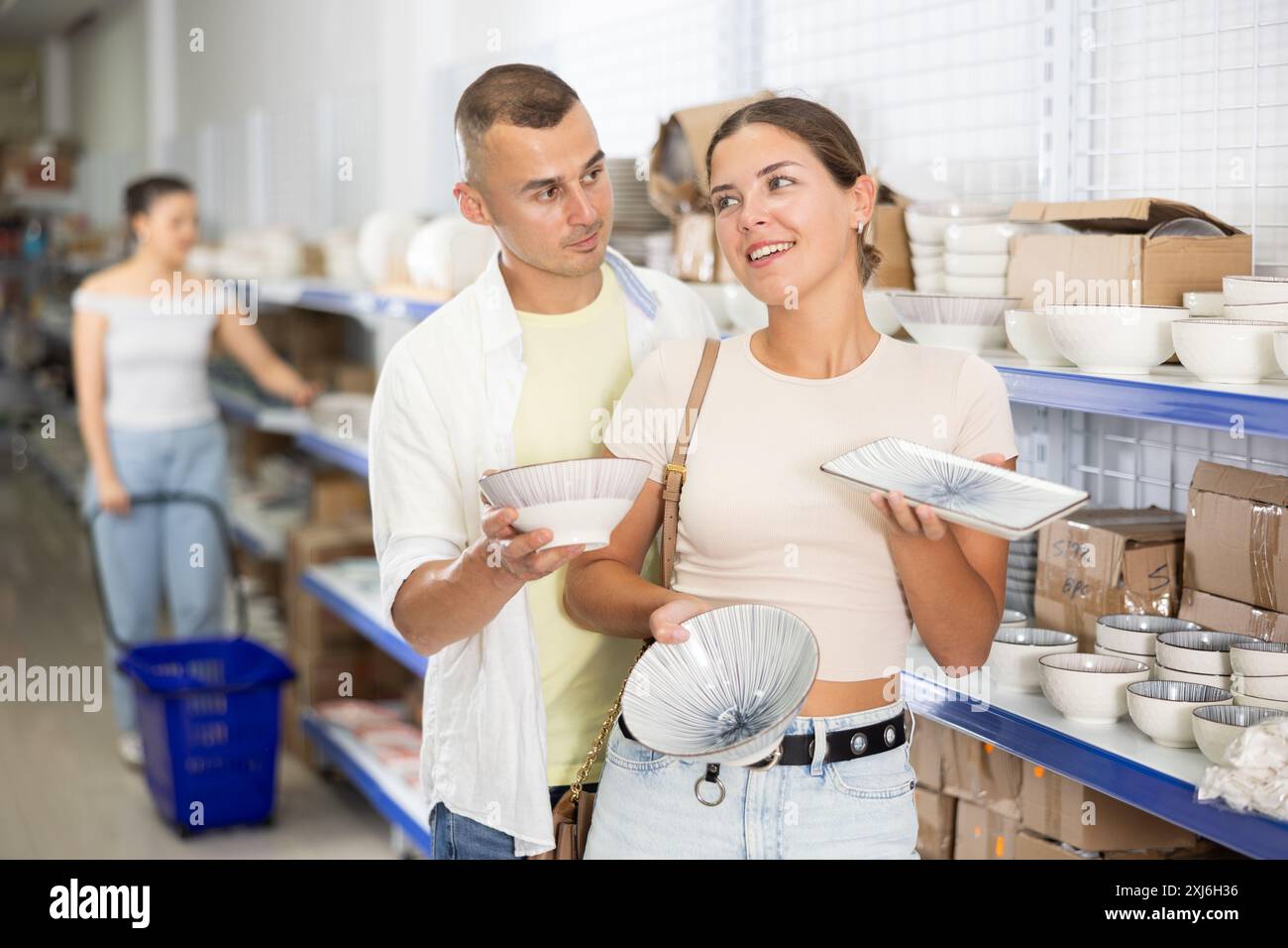 Married couple chooses plates for the kitchen and food together in ...