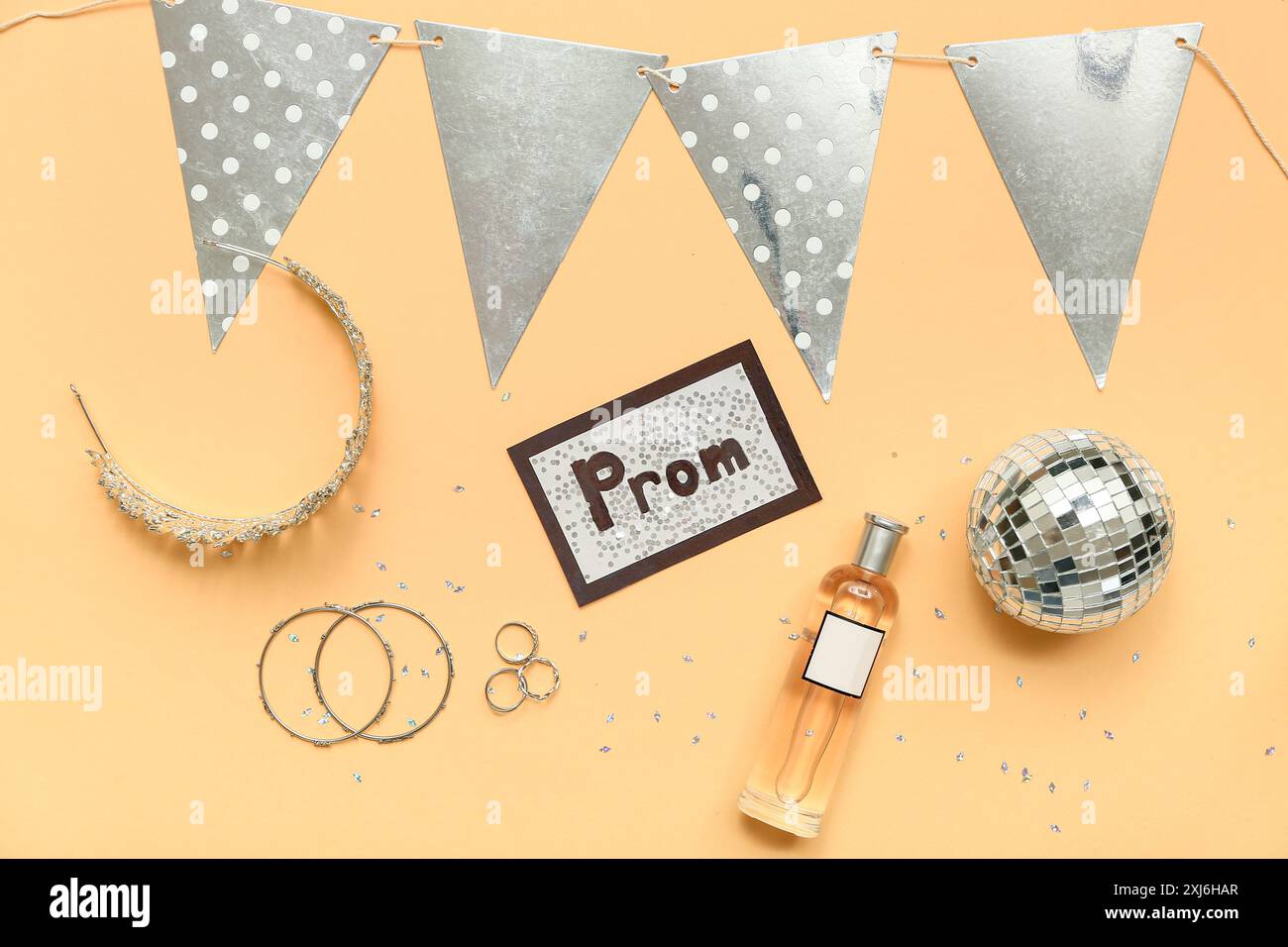 Word PROM with tiara, disco ball and perfume bottle on beige background ...