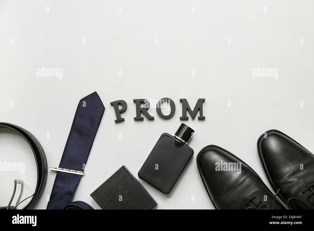 Word PROM with male shoes, perfume bottle and tie on white background ...